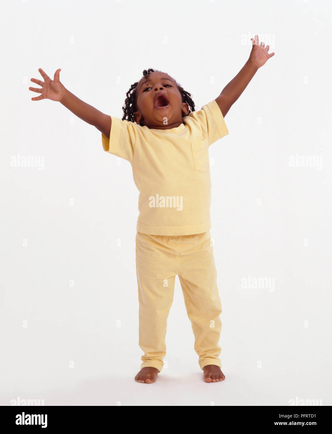 Young girl raising arms in the air Stock Photo - Alamy