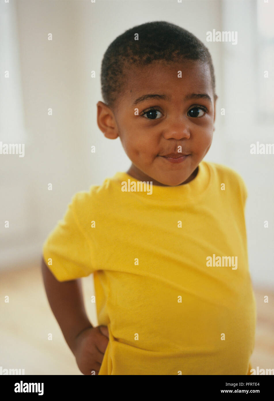 Cute toddler wearing yellow standing standing with hands on hips Stock ...