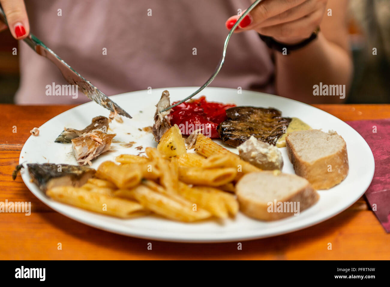 Girl eating from a Traditional Italian lunch Pasta plate hands cutting ...