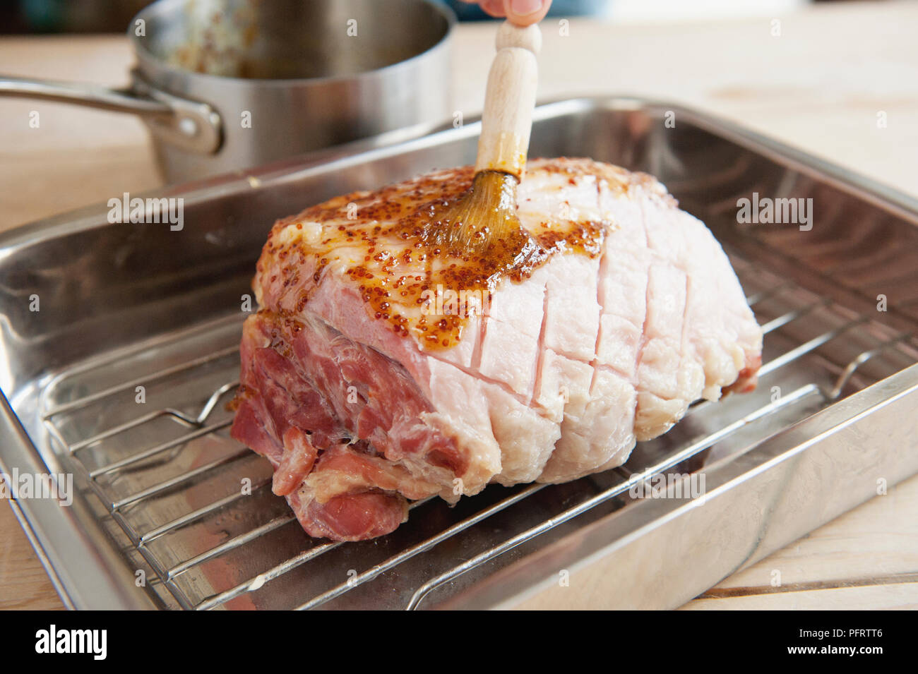 Brushing glaze over gammon Stock Photo - Alamy