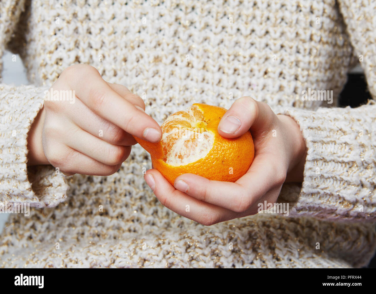 Child peeling orange hi-res stock photography and images - Alamy