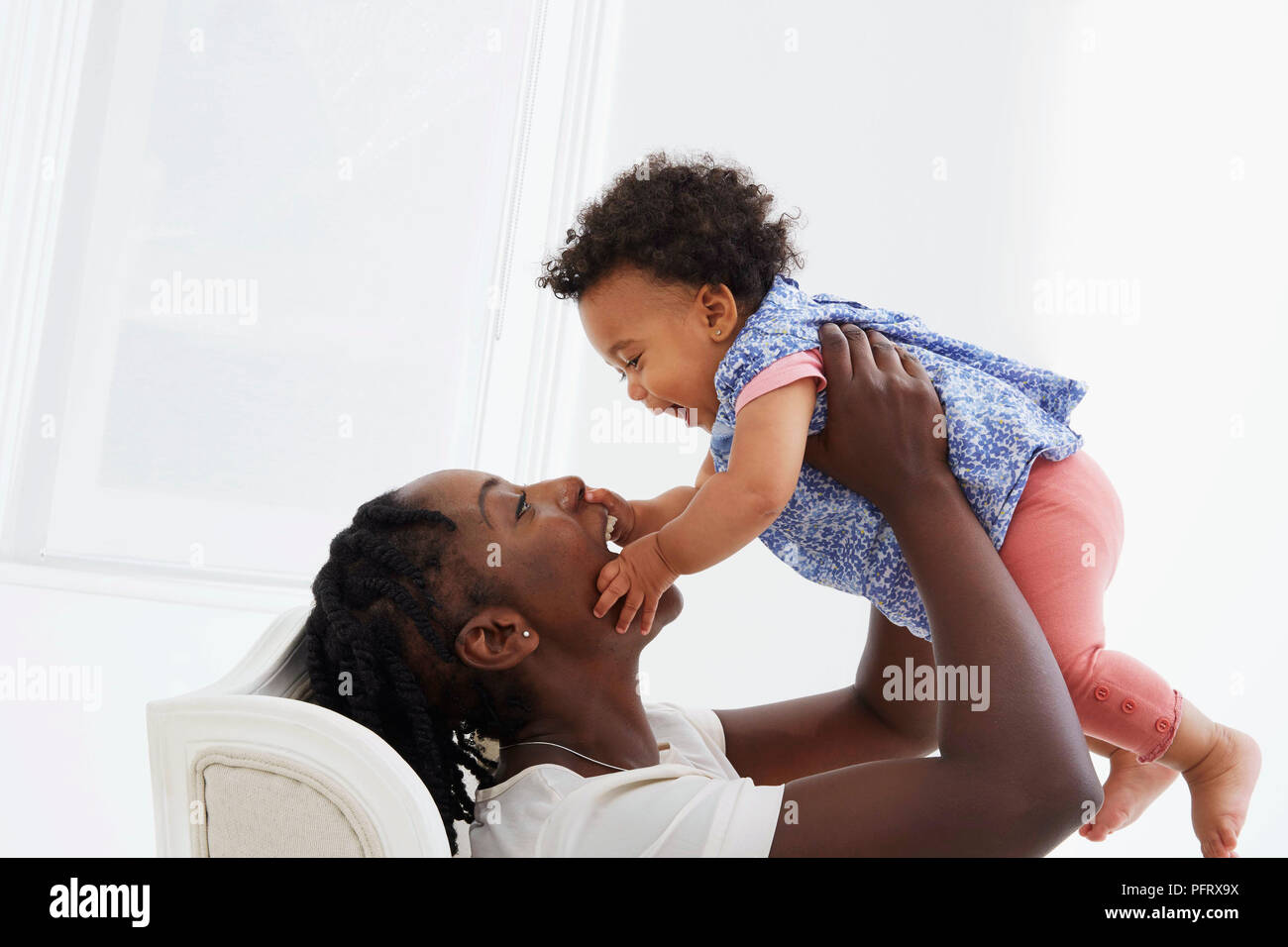 Mother lifting baby (Model aged 7.5 months Stock Photo - Alamy