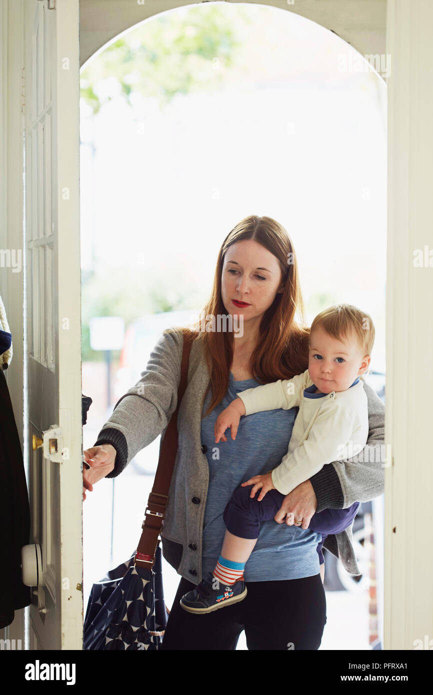 Mother carrying baby inside (Model aged 17 months Stock Photo - Alamy