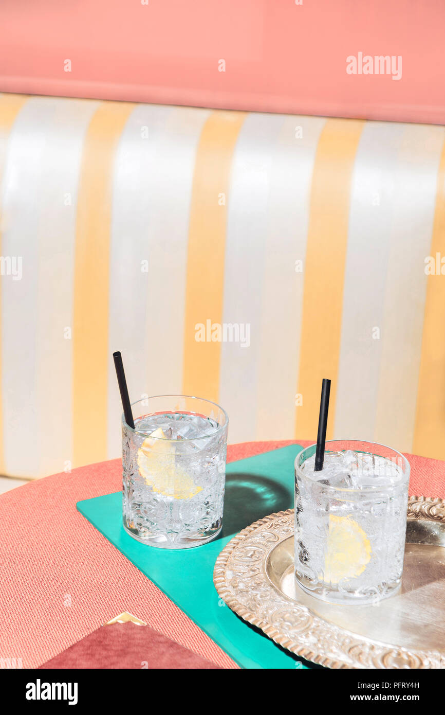 Gin and tonic on a table, into a colorful pop bar Stock Photo - Alamy