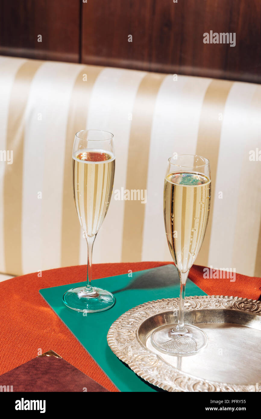 Two flutes of prosecco in an elegant bar with vintage pop colors Stock ...