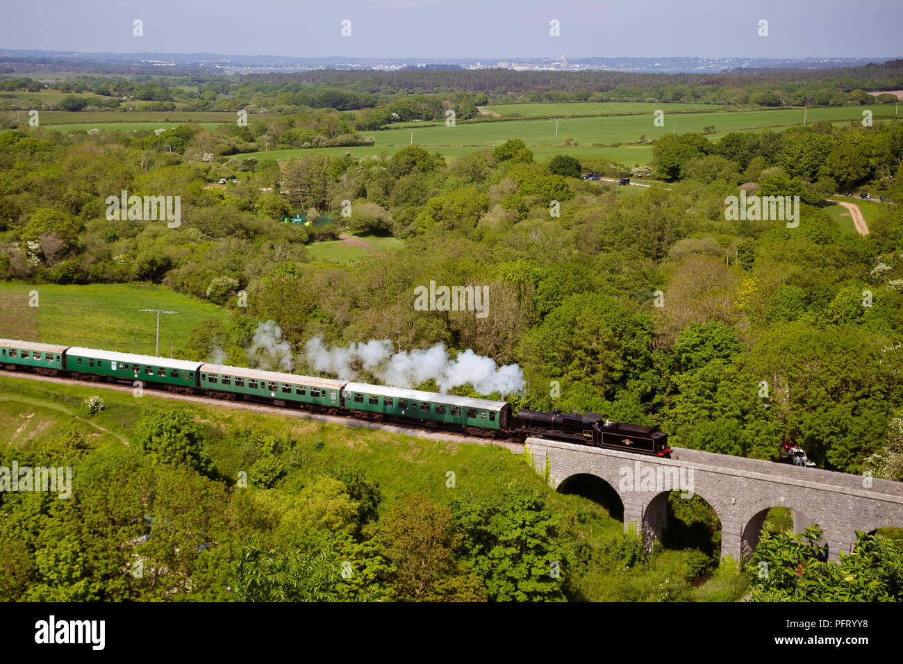 An old steam train on a bridge in countryside, England, UK Stock Photo ...
