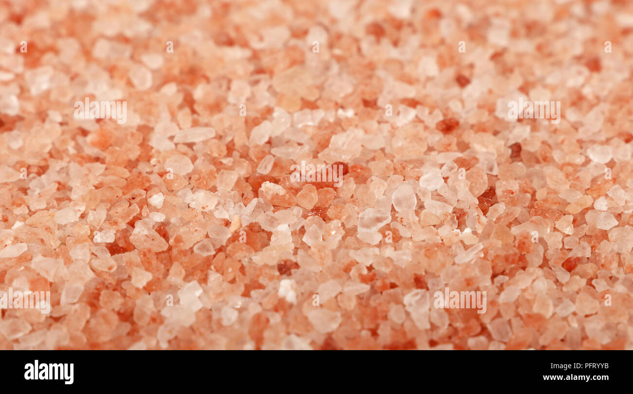 Close up background texture of large and medium crystals pink Himalayan ...
