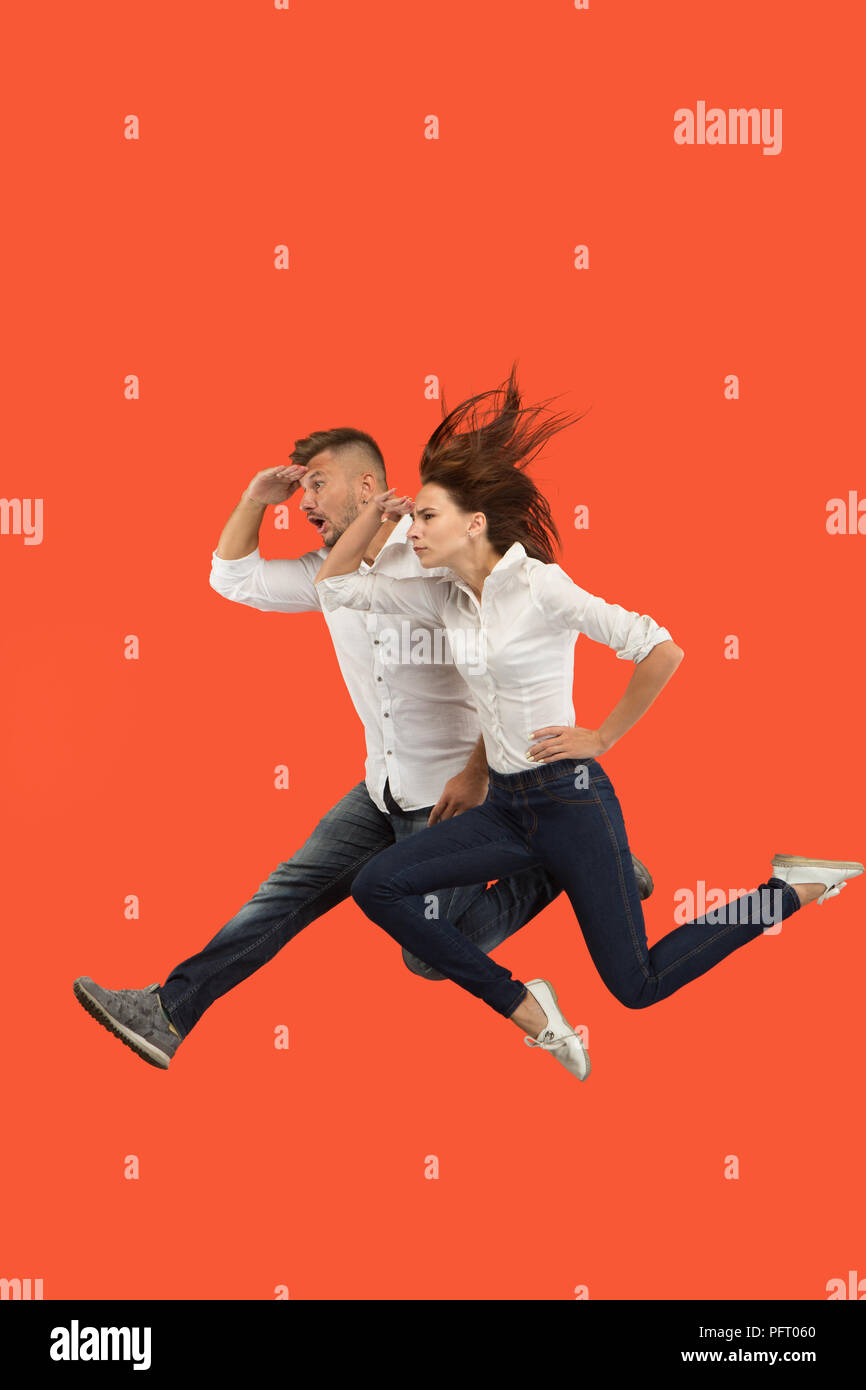 Freedom in moving and forward motion. The happy young couple jumping ...