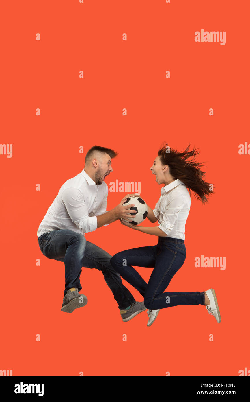 Forward to the victory.The young couple as soccer football player ...