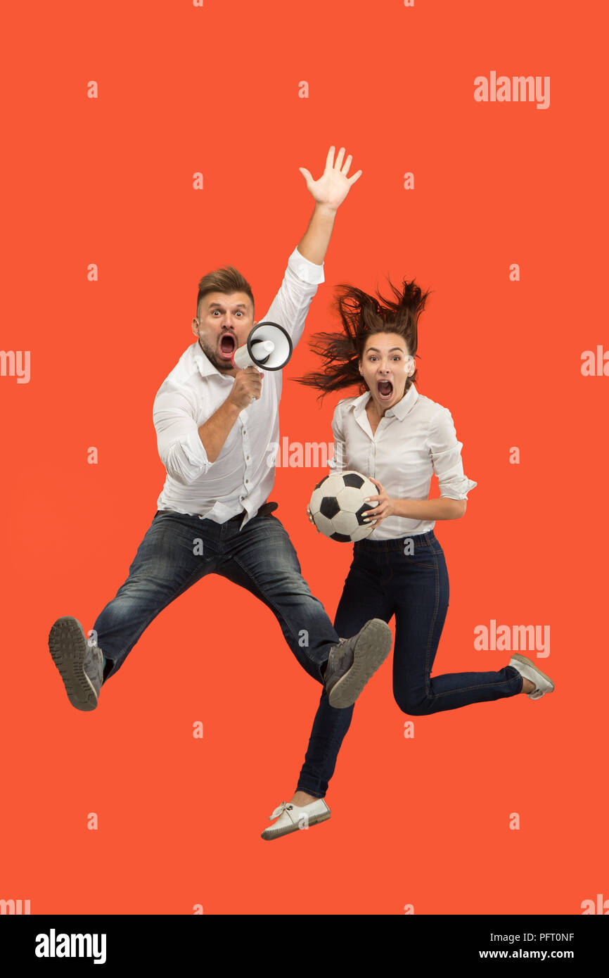 Forward to the victory.The young couple as soccer football player ...
