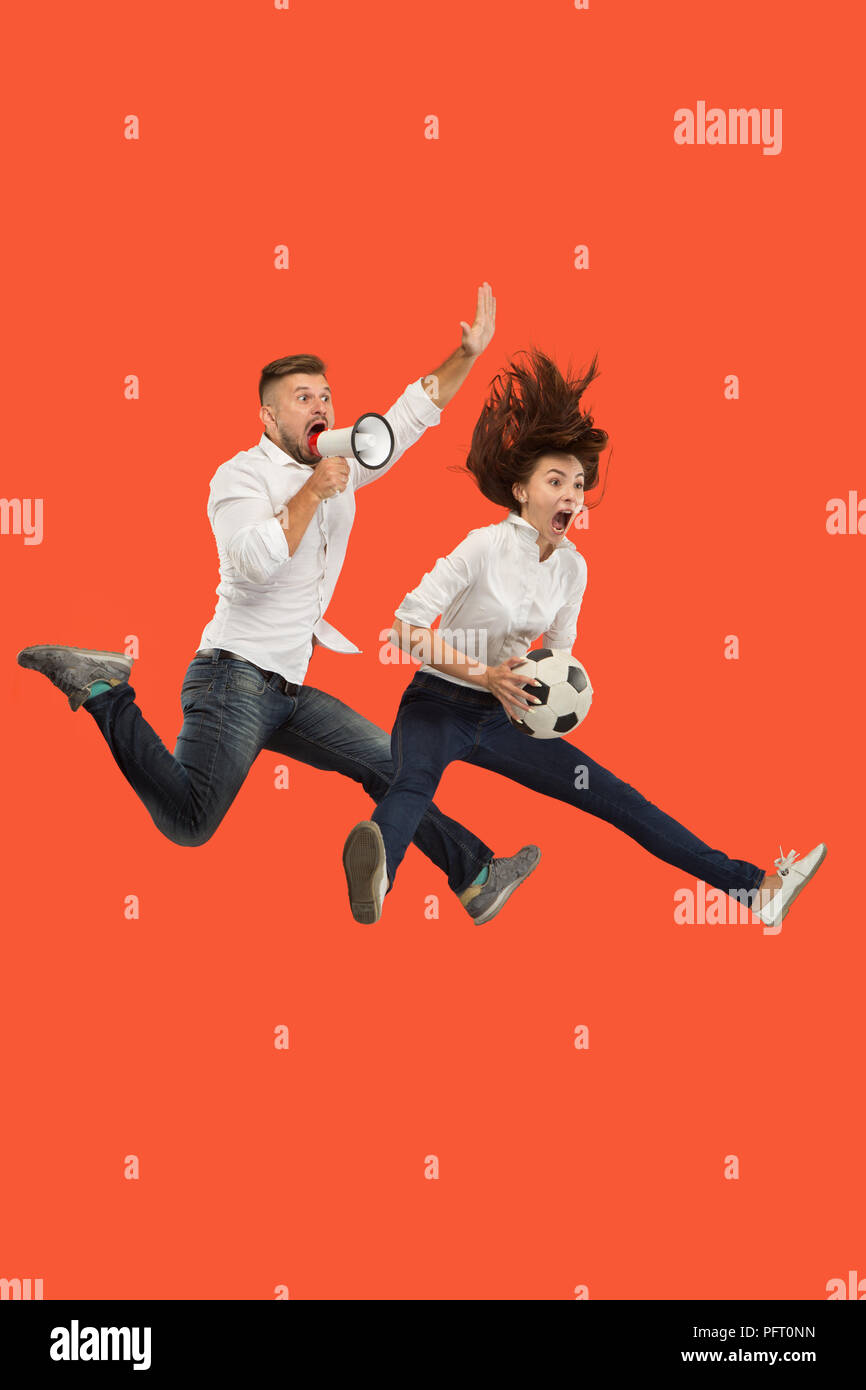 Forward to the victory.The young couple as soccer football player ...