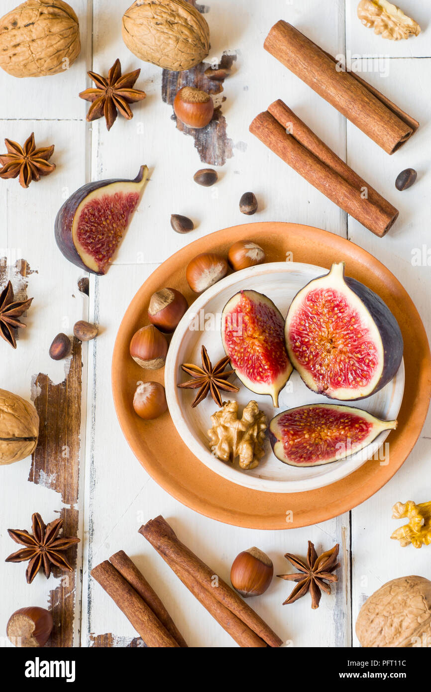 Fig walnuts cinnamon anise on a plate of old wooden background Stock ...