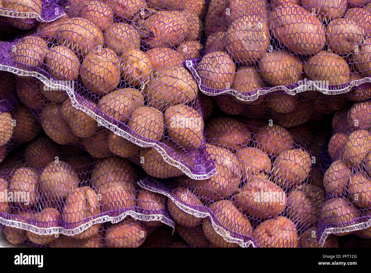 The background of potatoes in mesh bags Stock Photo - Alamy