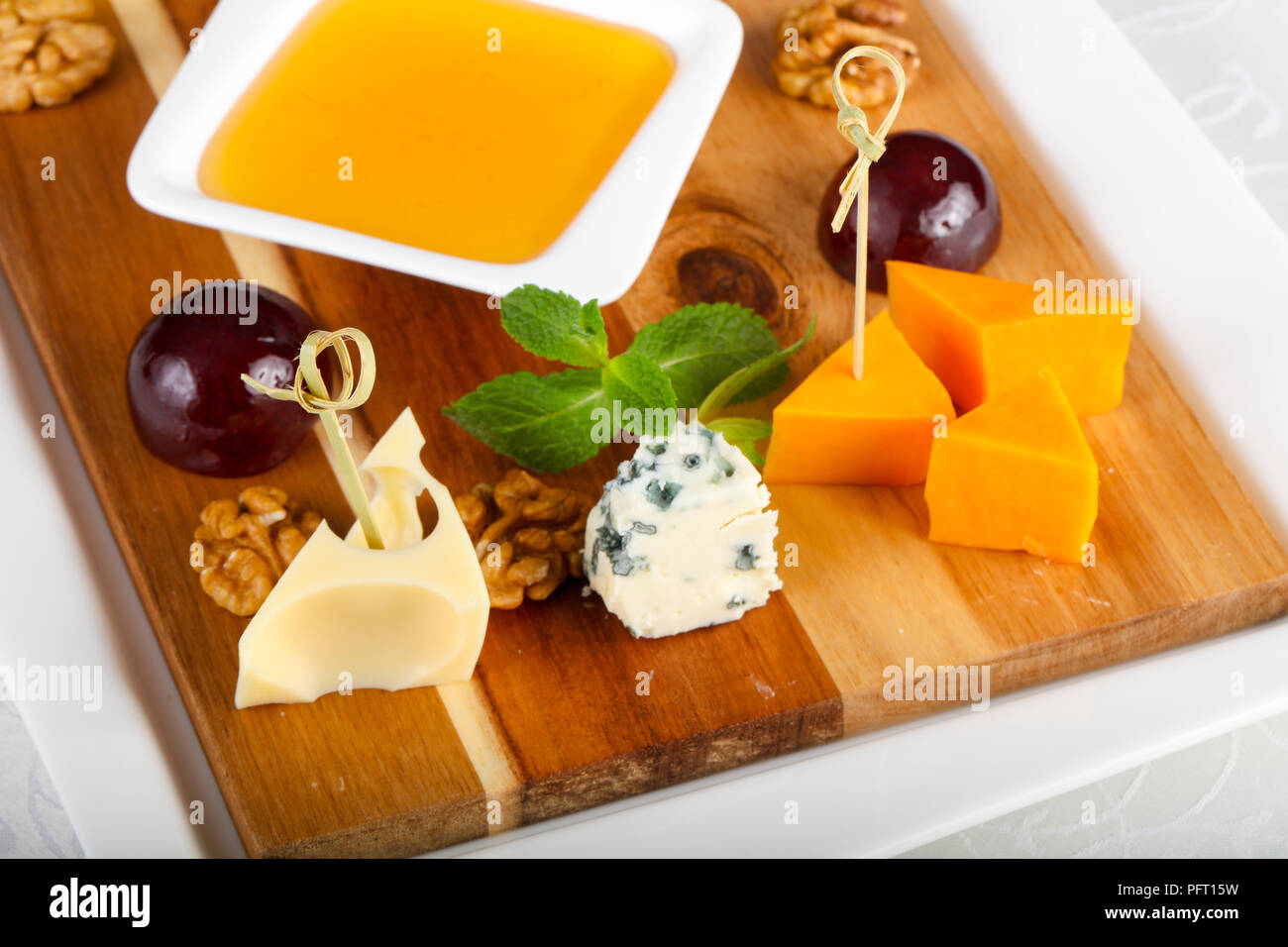 Cheese plate mix with grape, honey and nuts Stock Photo - Alamy
