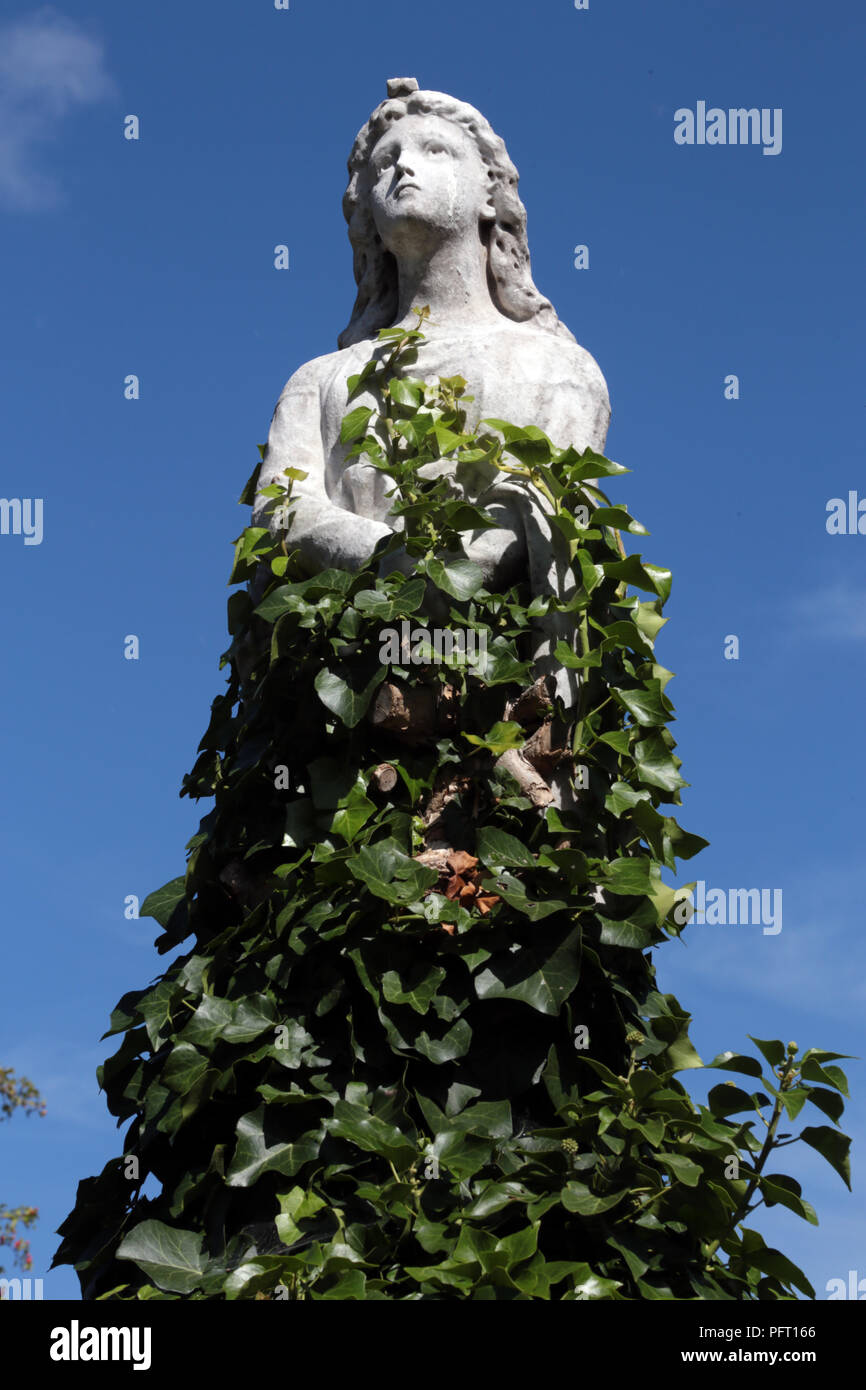 Statue of a woman partially covered in ivy Arnos Vale Cemetery ...