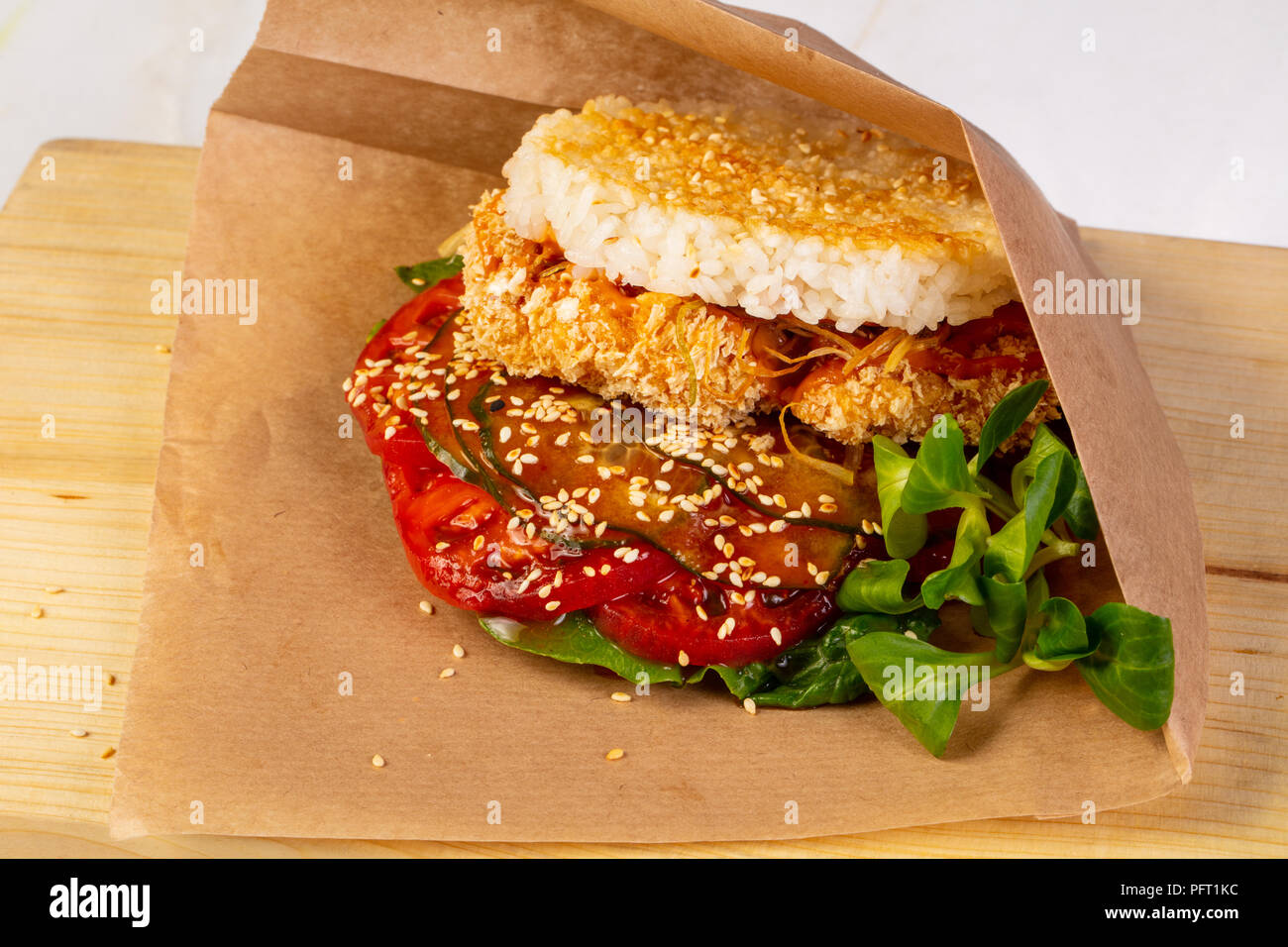 Rice burger with crispy chicken Stock Photo - Alamy