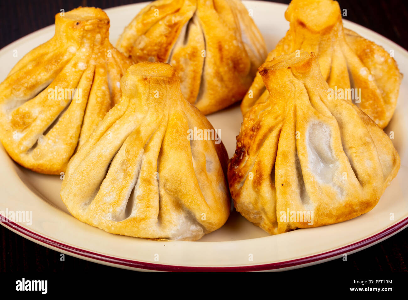 Roasted meat khinkali in the bowl Stock Photo - Alamy