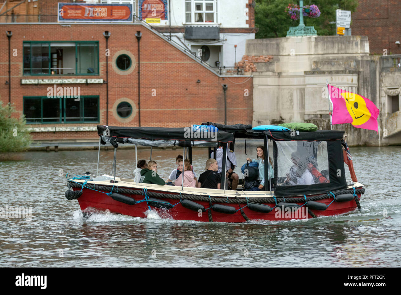 Festival goers get a boat across the River Thames as they arrive for ...