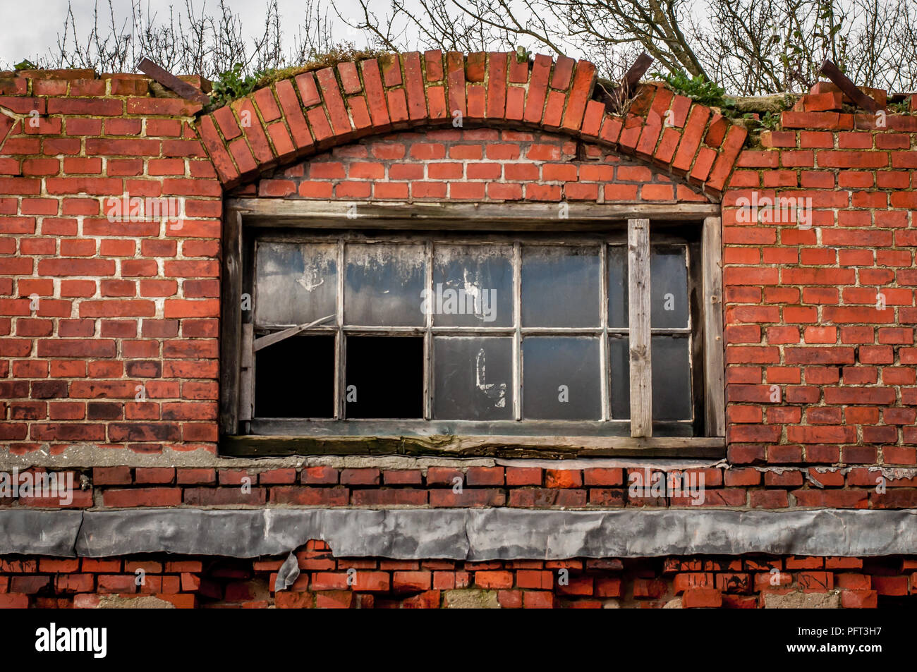 Broken windows in a old building with broken bricks Stock Photo - Alamy