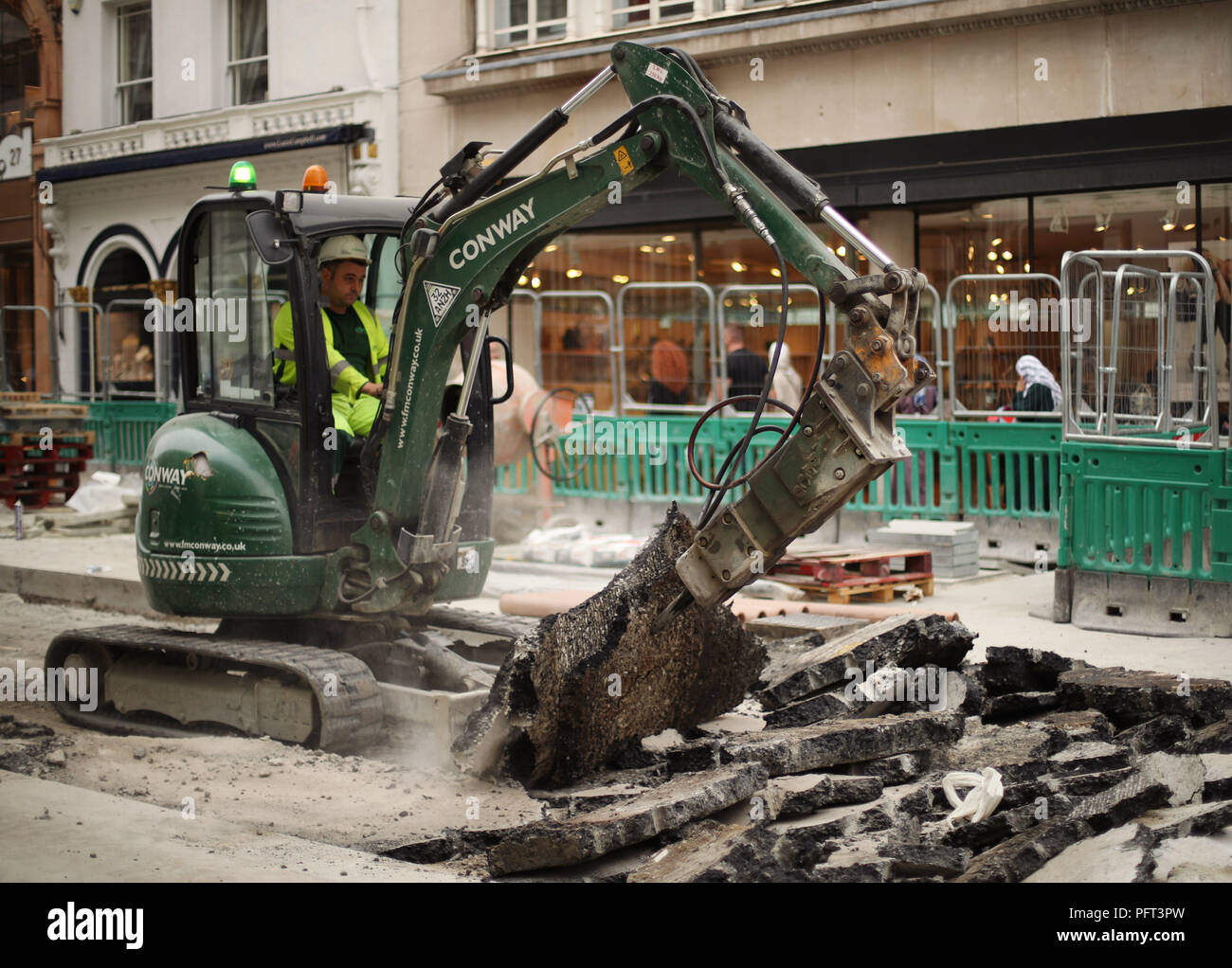 A worker from FM Conway digging up the road surface of New Bond Street ...