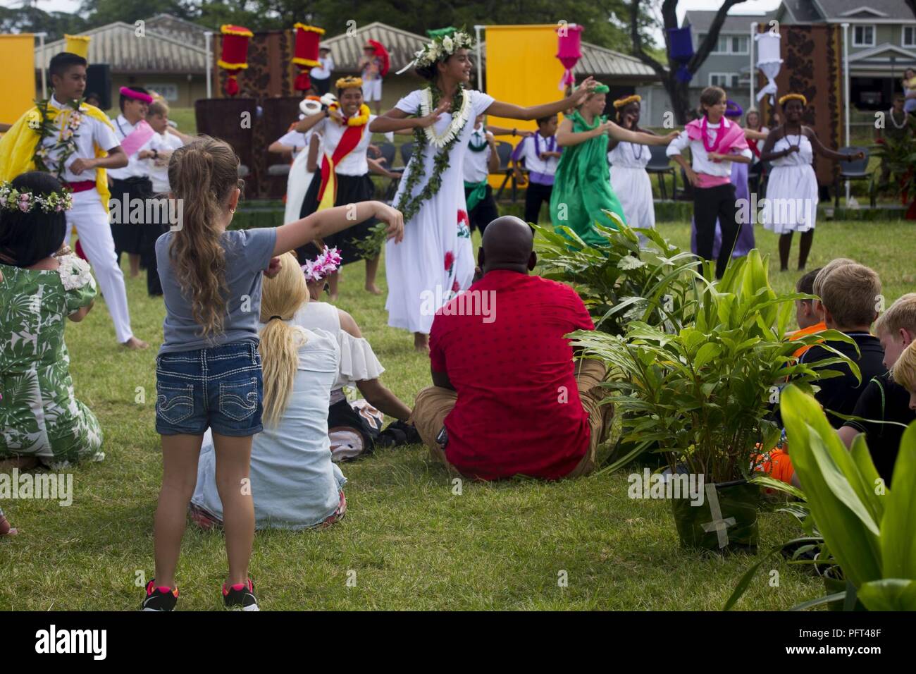 A child imitates students from Mokapu Elementary School performing a ...