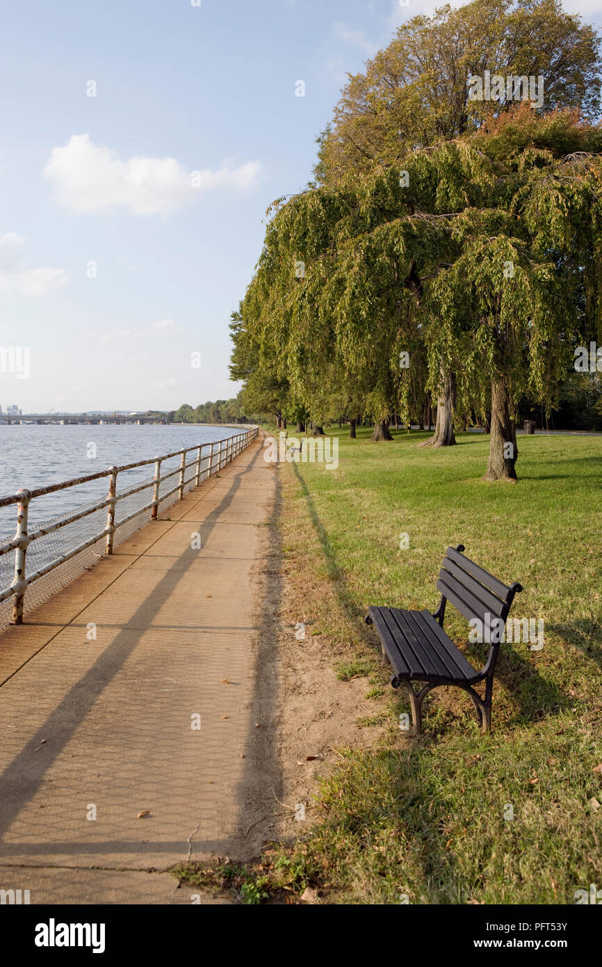 USA, Washington DC, East Potomac Park, bench by the side of footpath ...