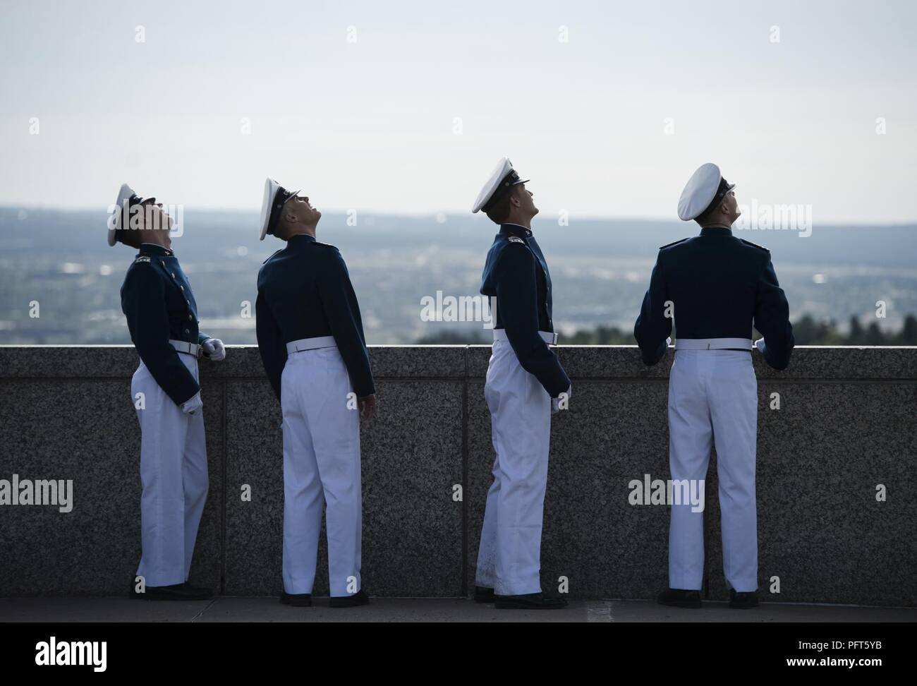 U.S. Air Force Academy cadets look up and watch as gliders fly overhead ...