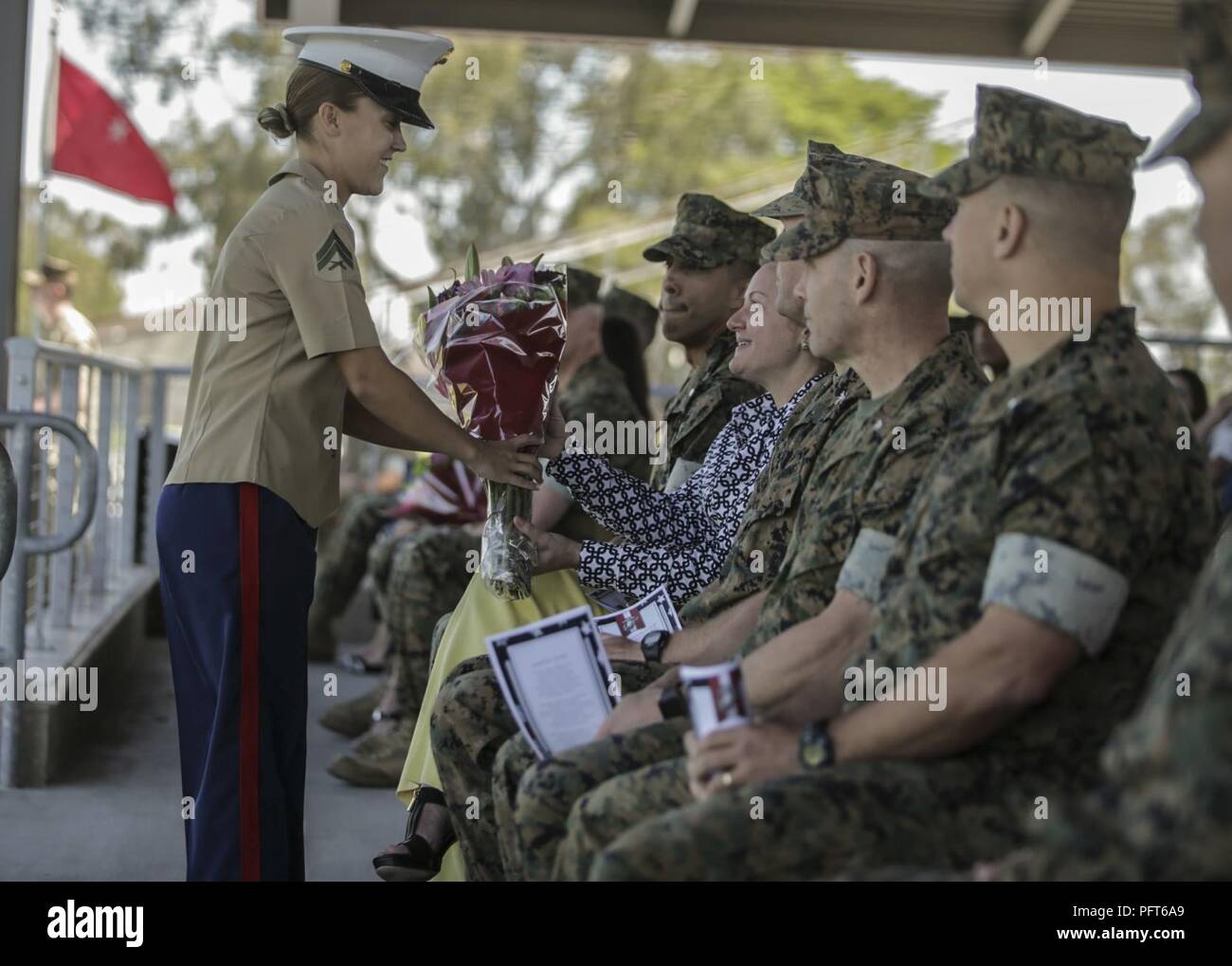 U.S. Marine Lt. Col. Matthew D. Woods’ wife CJ Woods receives flowers ...