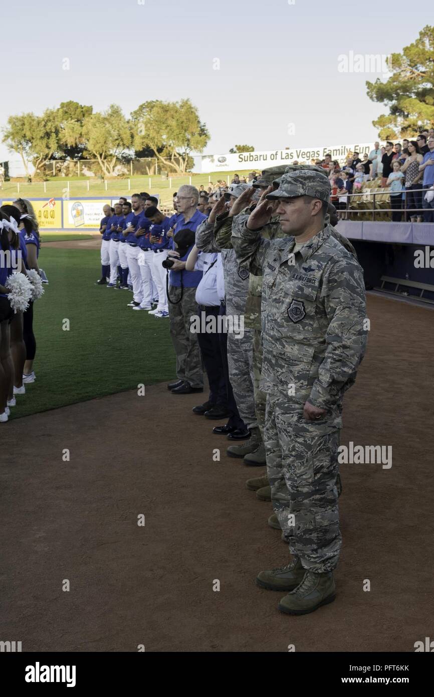Military members, baseball players and fans pay respect to the flag ...