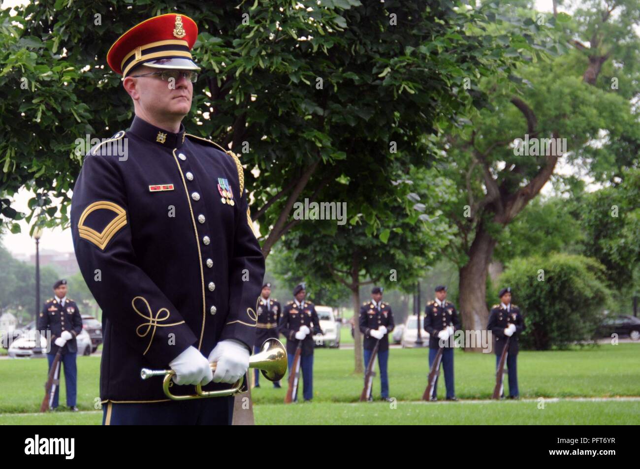 An Old Guard bugler and the D.C. National Guard Rifle Team stand ready ...