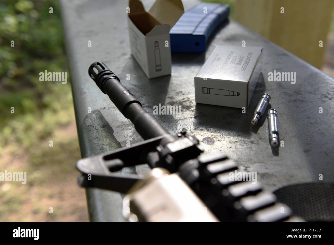 An M-4 carbine rifle rests on a table alongside a magazine and ...