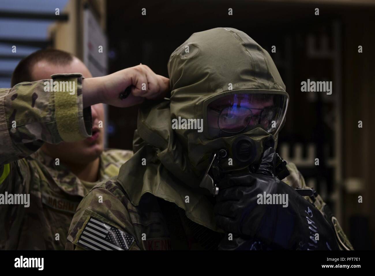 A 15th Special Operations Squadron aircrew member is assisted with his ...