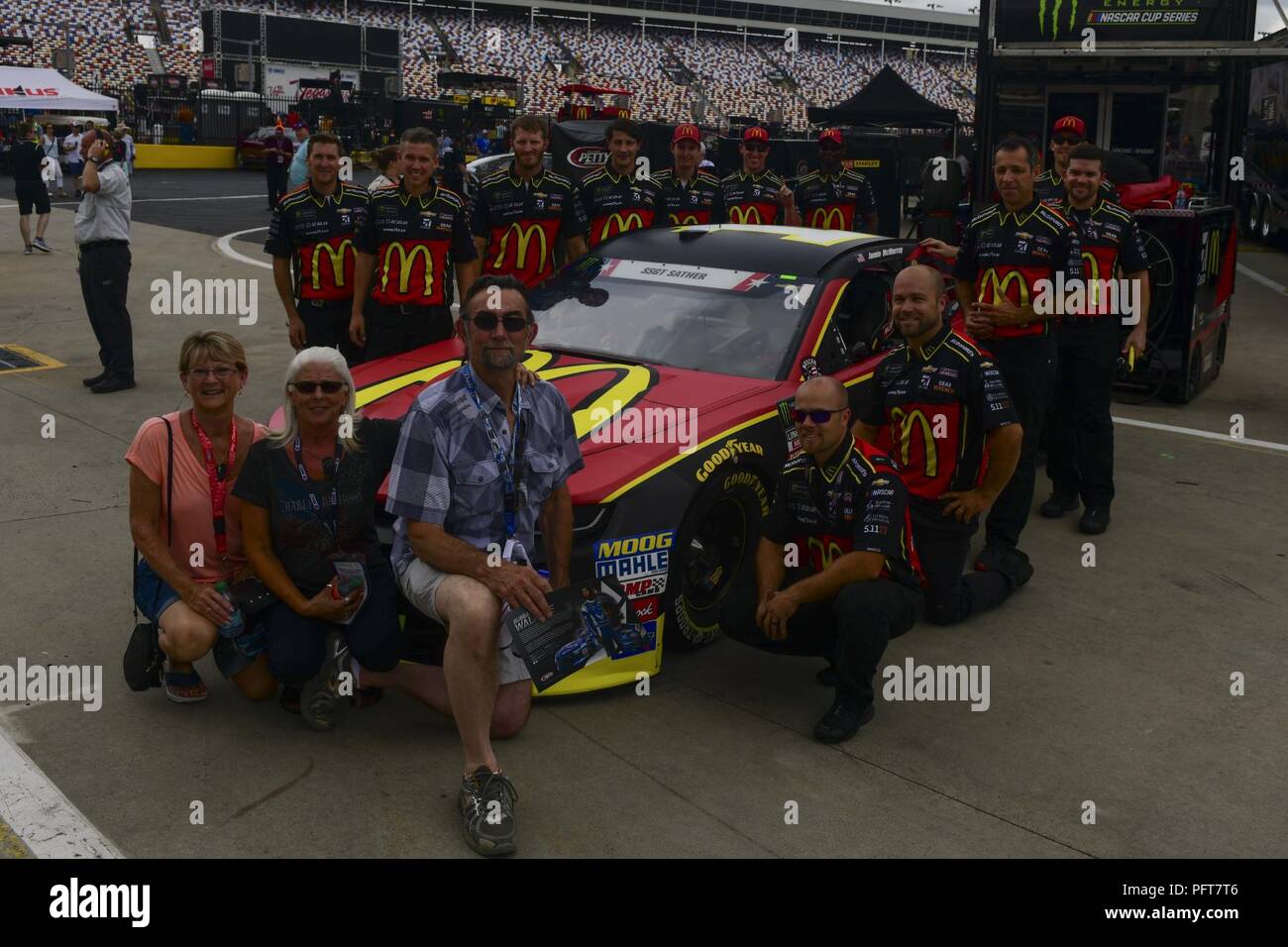Family members of Staff Sgt. Scott Sather pose with the pit crew of the ...