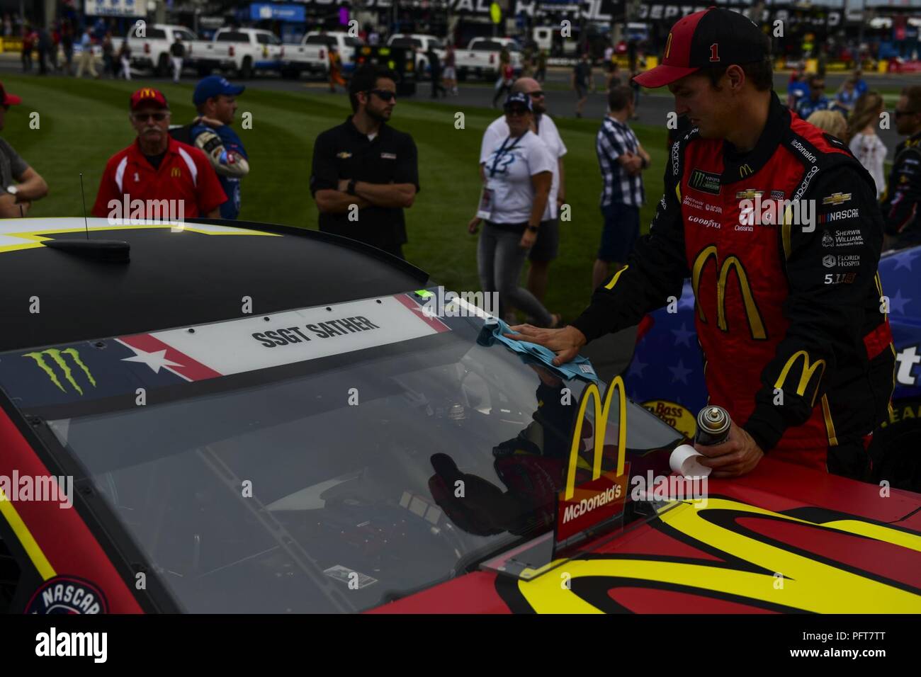 A crew member washes the windshield of the #1 McDonald’s Chevy, which ...