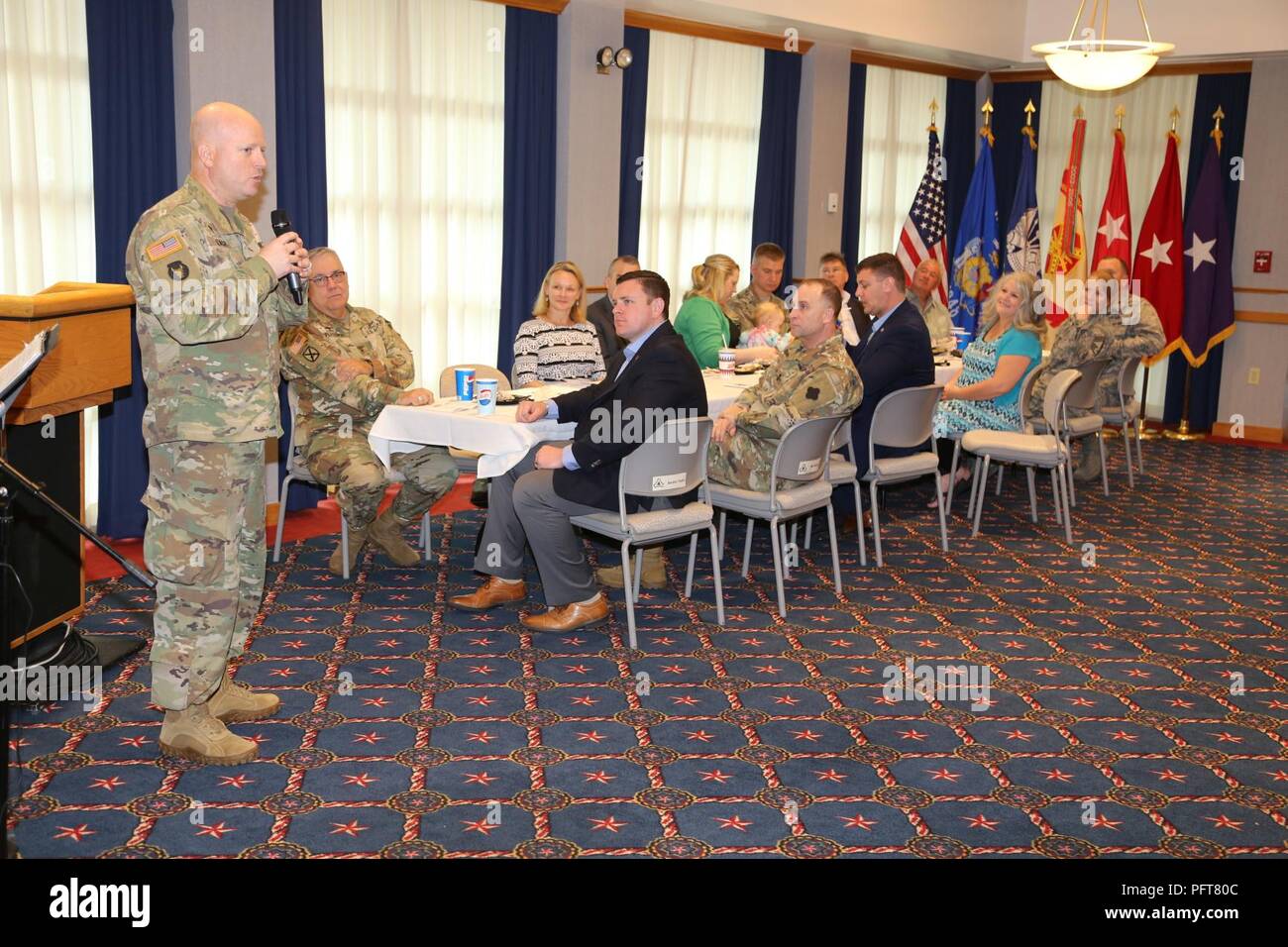 Chaplain (Lt. Col.) Raymond Leach, garrison chaplain, talks to community members during the ...