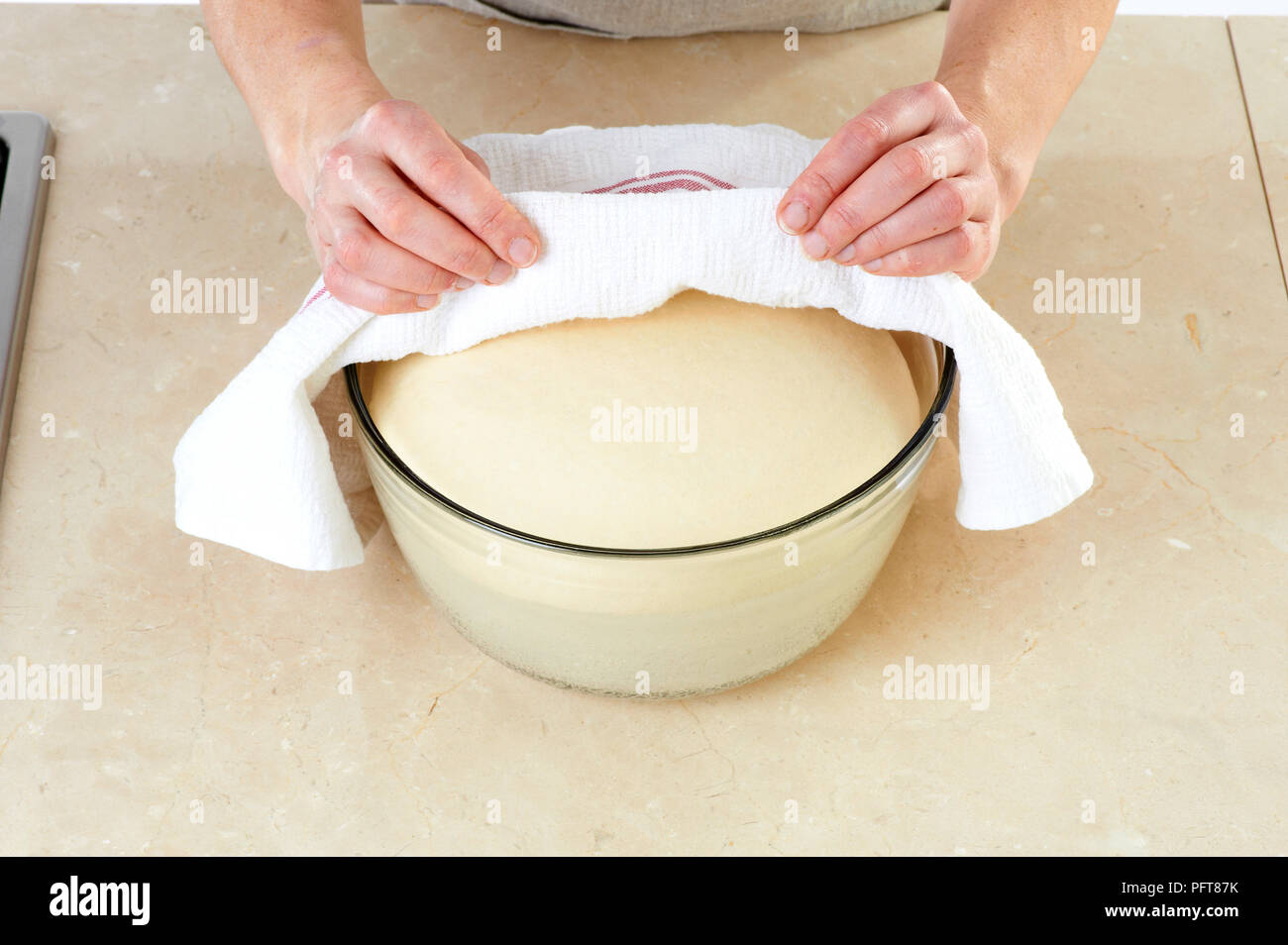 Man using tea towel to cover soughdour bread dough in mixing bowl Stock ...