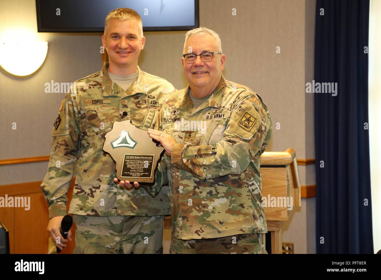 Lt. Col. Jared Corsi, deputy garrison commander, presents an appreciation plaque to Chaplain ...