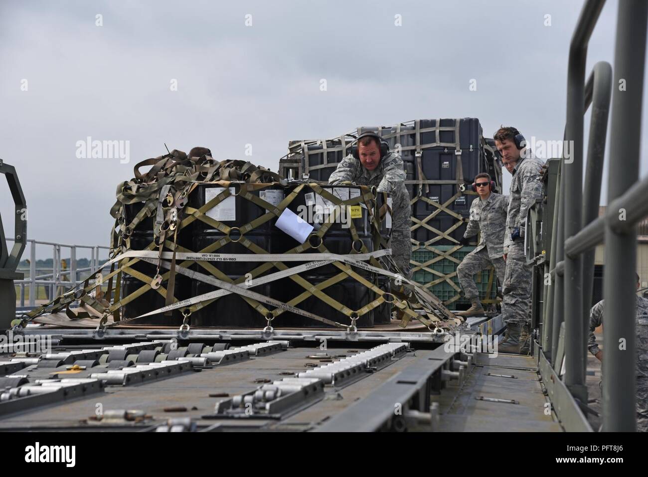Airmen from the 161st Logistics Readiness Squadron push a palletized ...