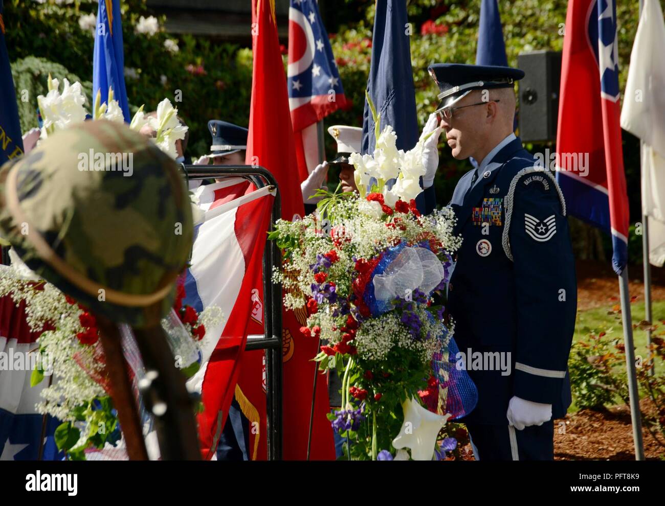 Washington Air National Guard Tech. Sgt. Keven Baker renders a salute ...