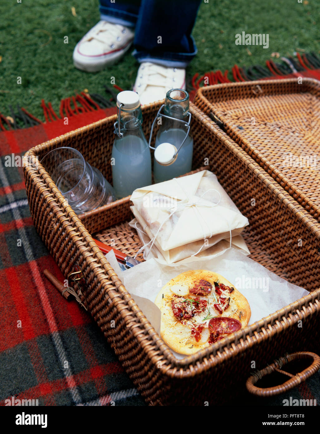 Open picnic basket on tartan blanket on grass Stock Photo - Alamy