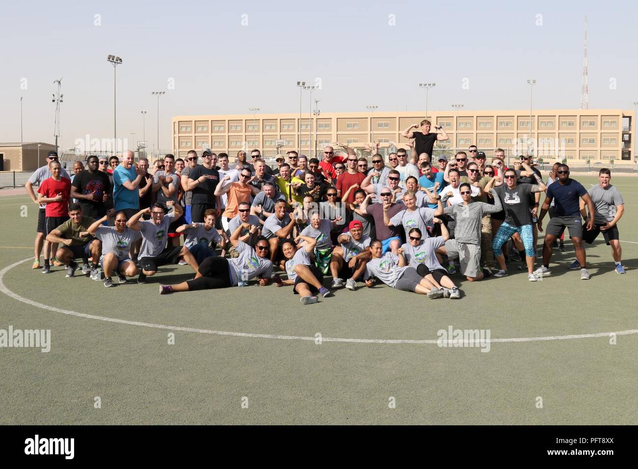 CAMP ARIFJAN, Kuwait — Soldiers flex their muscles as they pose for a ...