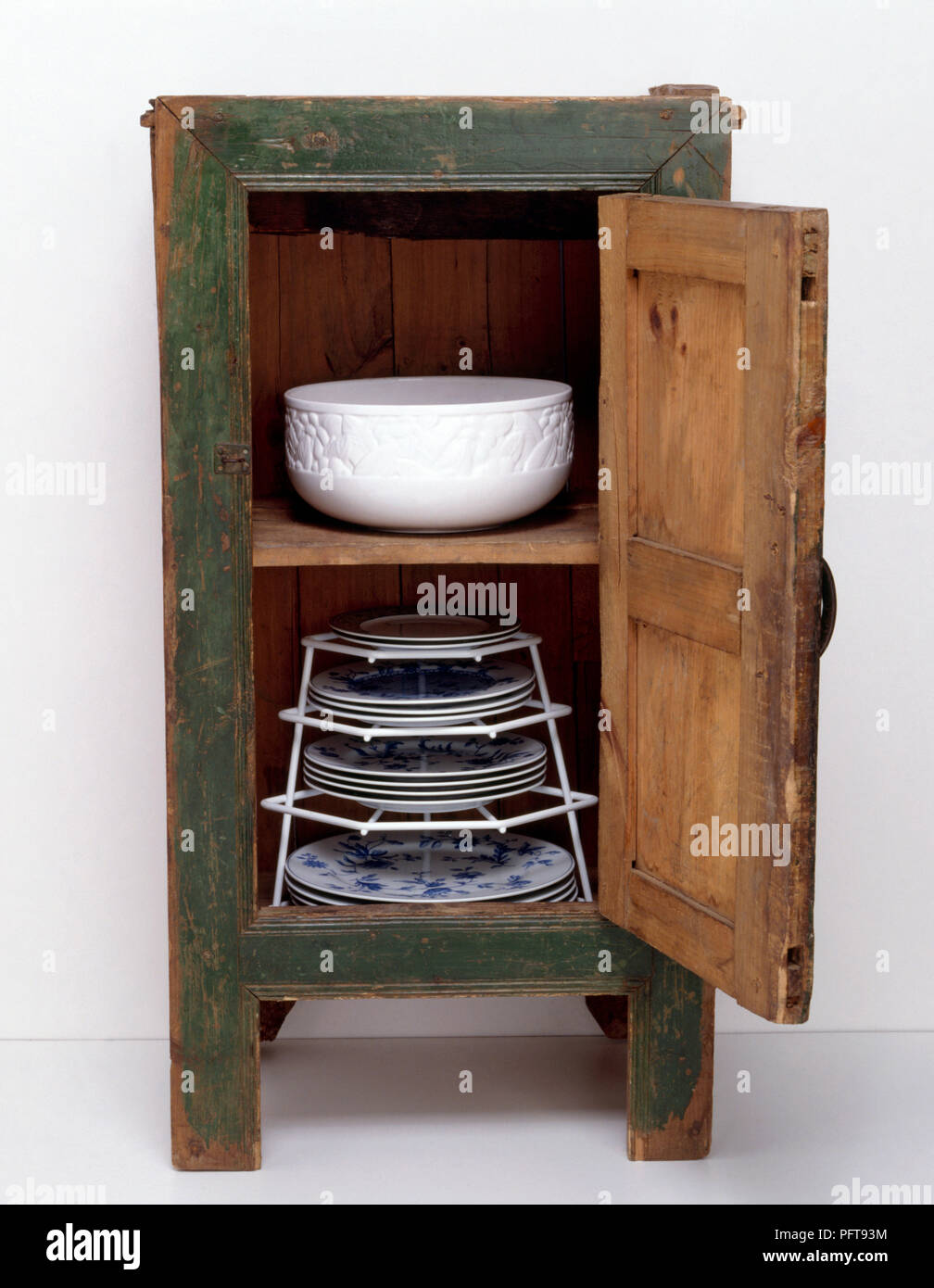 Bowl and plates on plate wrack inside retro revival rustic kitchen ...