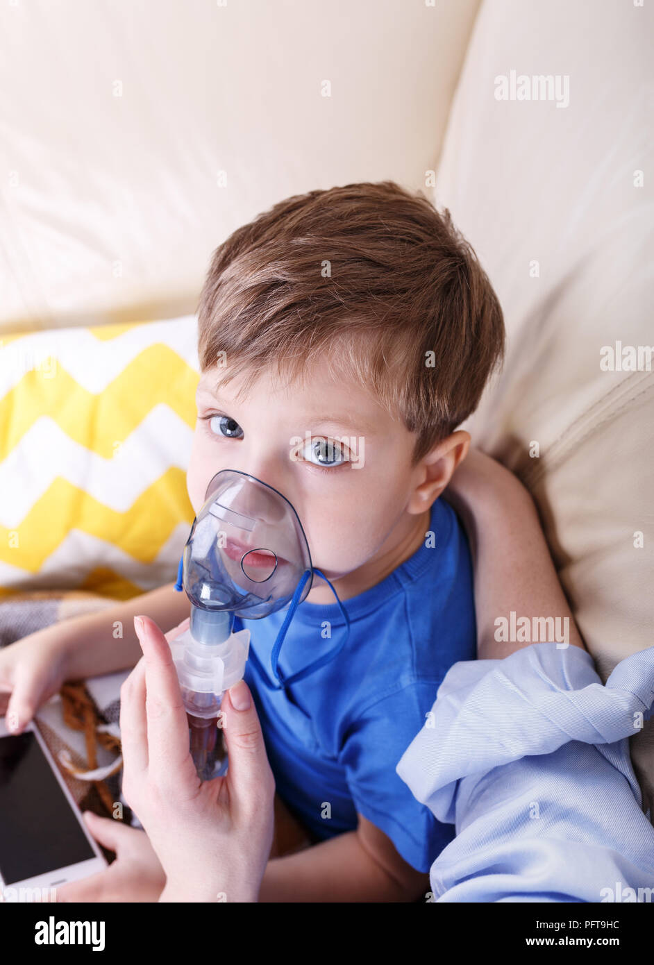 Boy breathe through nebulizer. Sick chid with pediatric nebulizer Stock ...