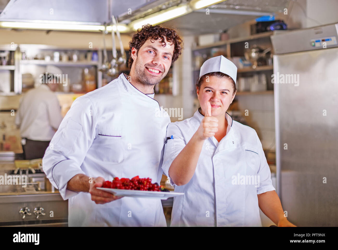 Two chefs cook together. Cooking process concept Stock Photo - Alamy