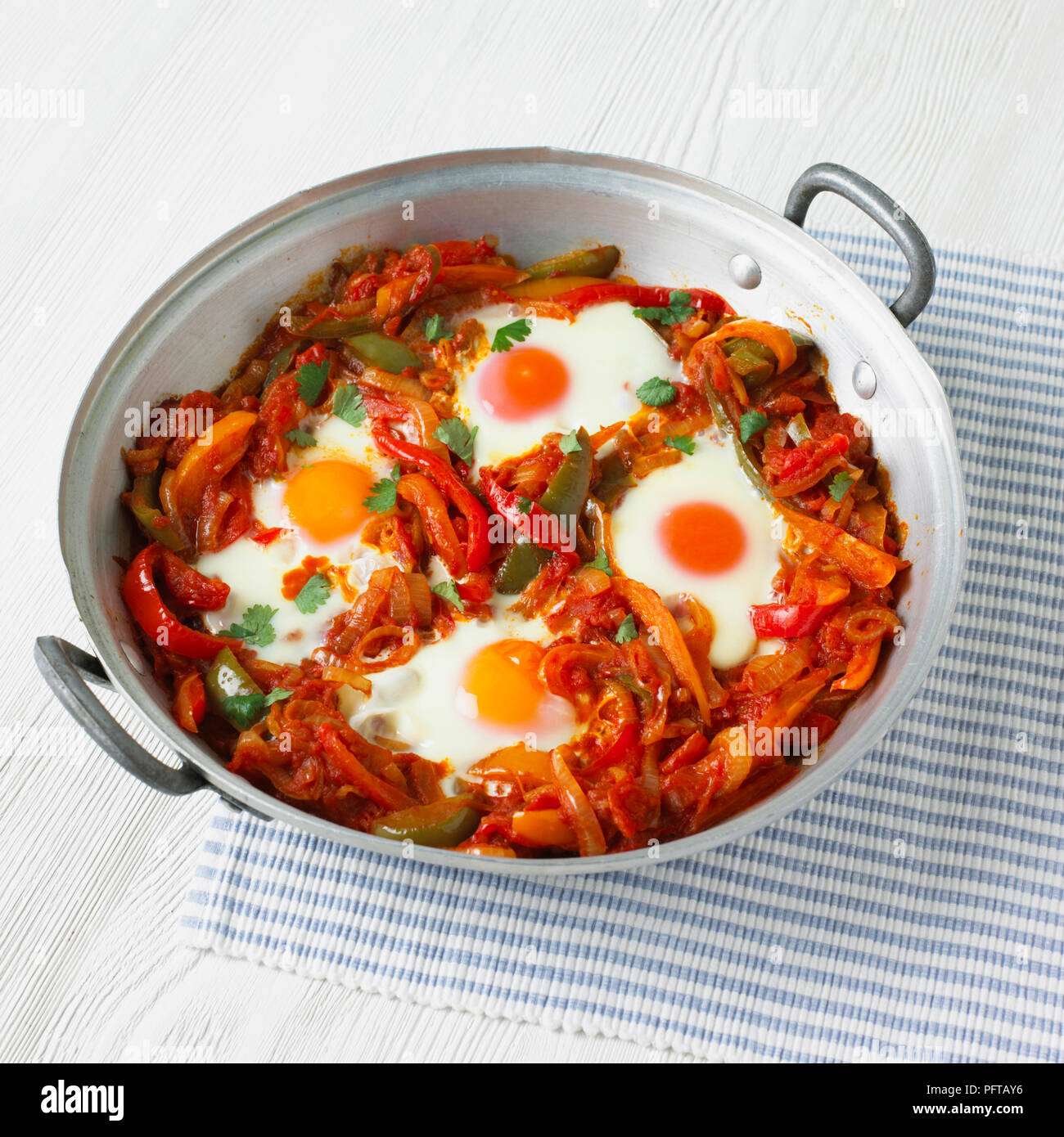 Menemen, Turkish one-pan dish containing onions, eggs, and peppers ...