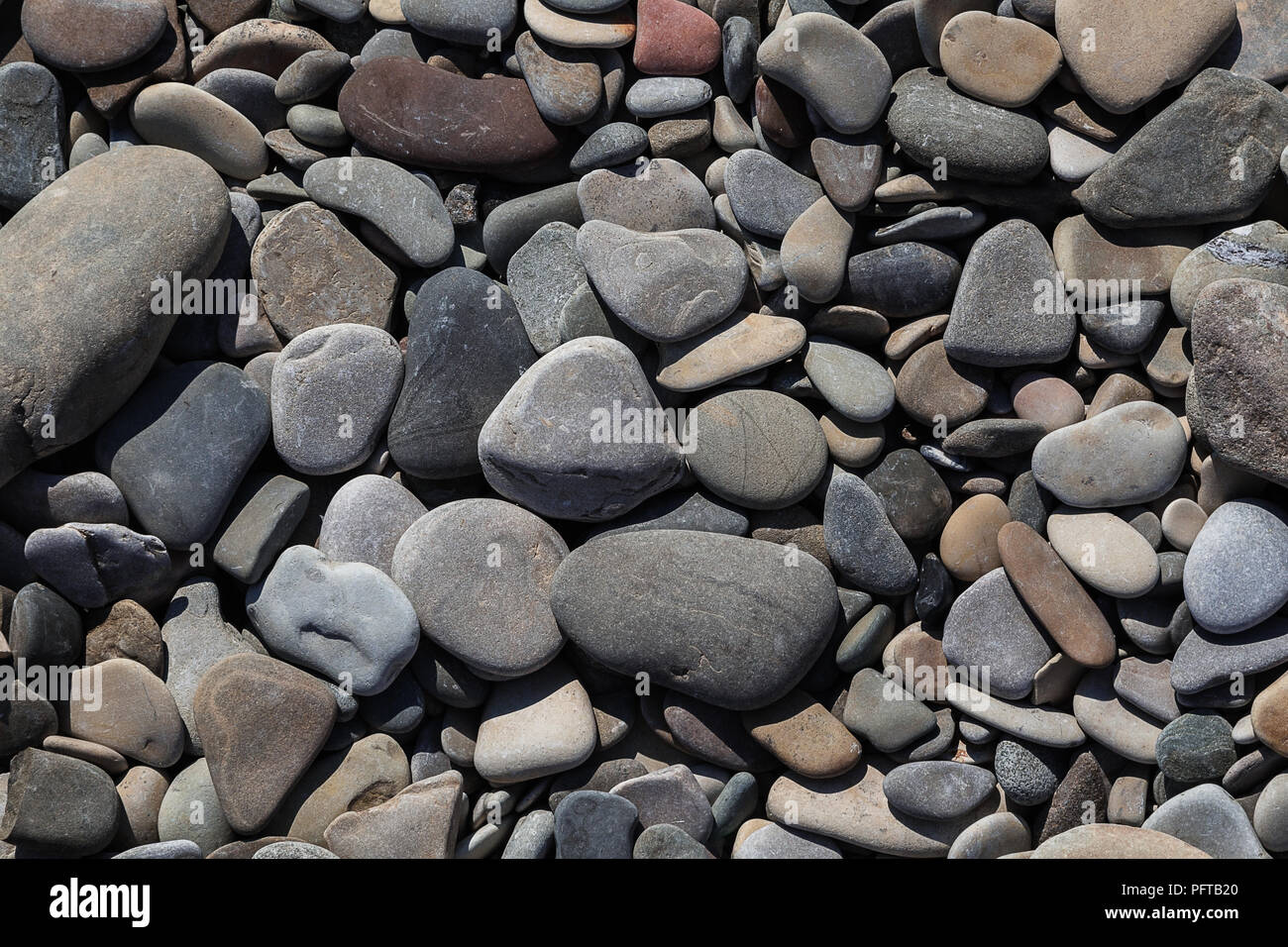 Round peeble stones background in close up Stock Photo - Alamy