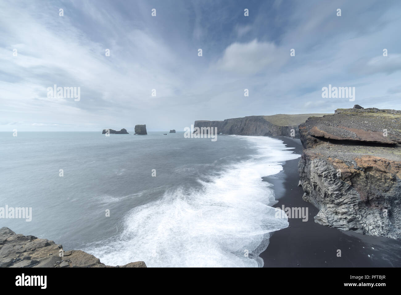 The dramatic ocean and cliff views of Dyrhólaey on the southern coast ...
