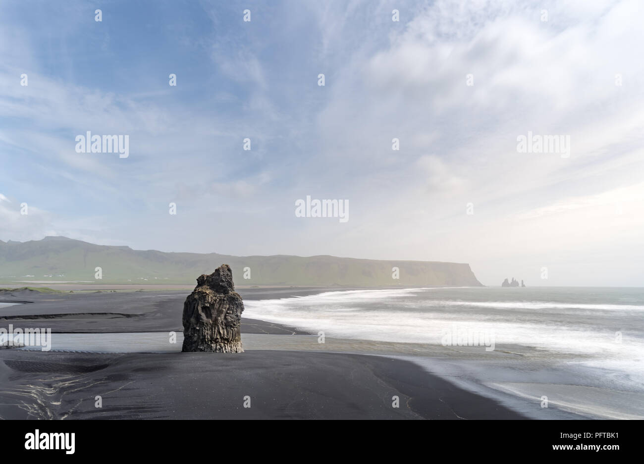 The dramatic view of the Reynisdrangar Sea Stacks and the black sand ...