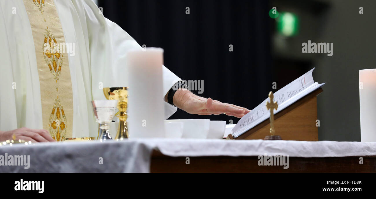 catholic priest hands serving mass at a liturgy. Images shows various ...