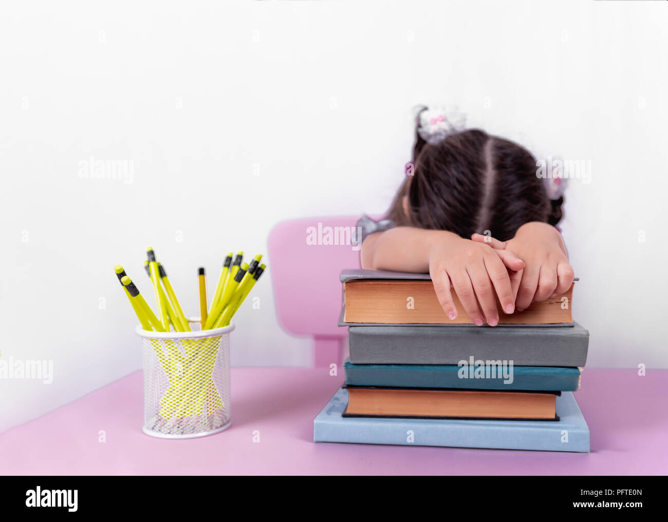 Cute little girl in school uniform sleeps on books.Selective focus and ...